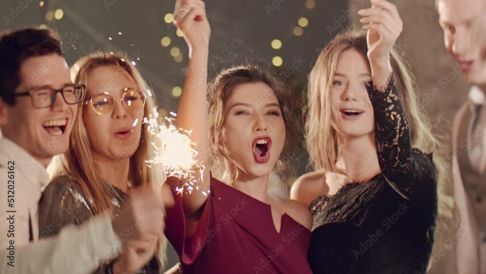 Asian girl and group young college student friends lit light sparkler ...