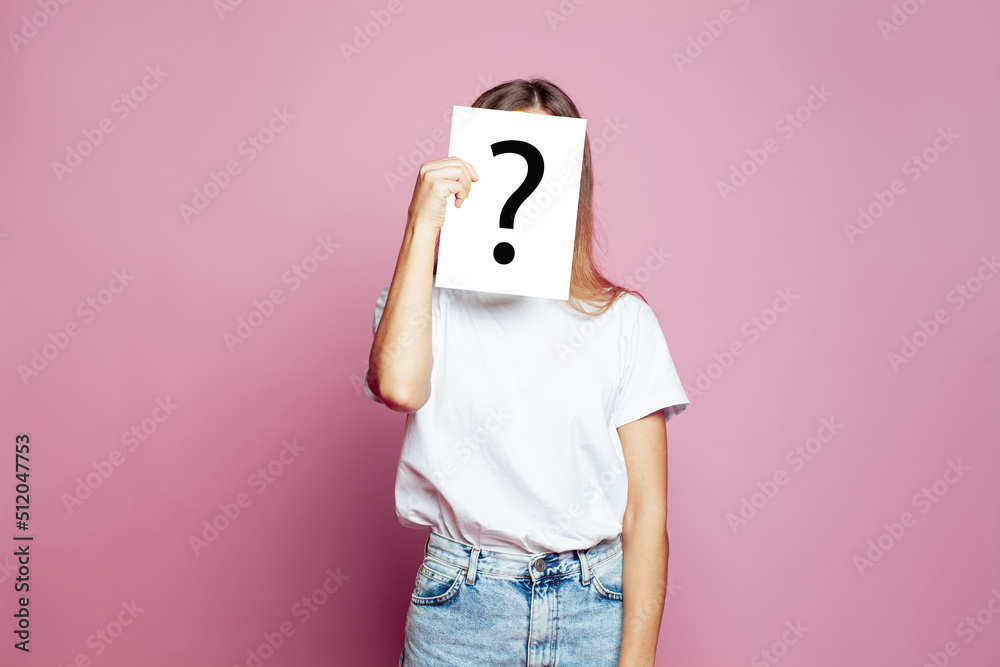 Pretty woman covering face using a white paper sheet with drawn ...