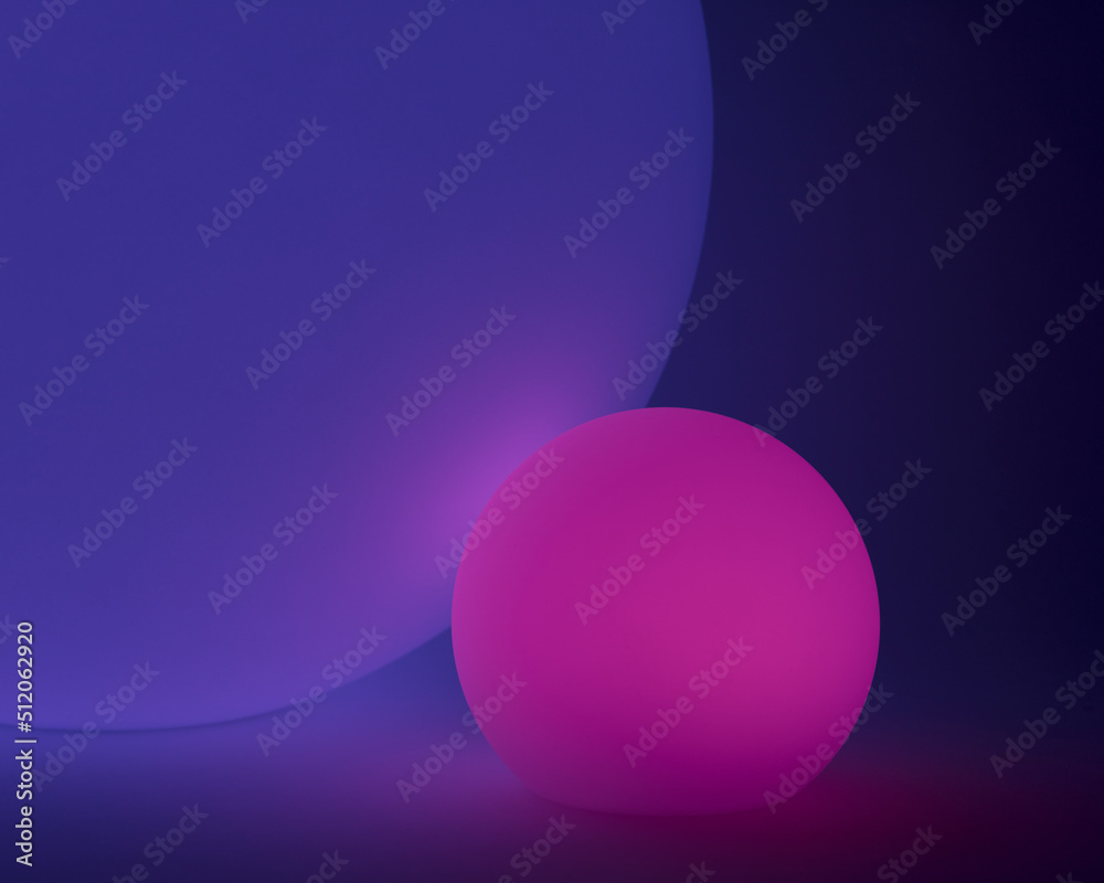 Glowing and illuminated spherical coloured orbs on a black background. Stock Photo | Adobe Stock