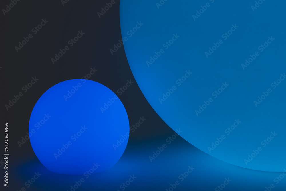 Glowing and illuminated spherical coloured orbs on a black background ...