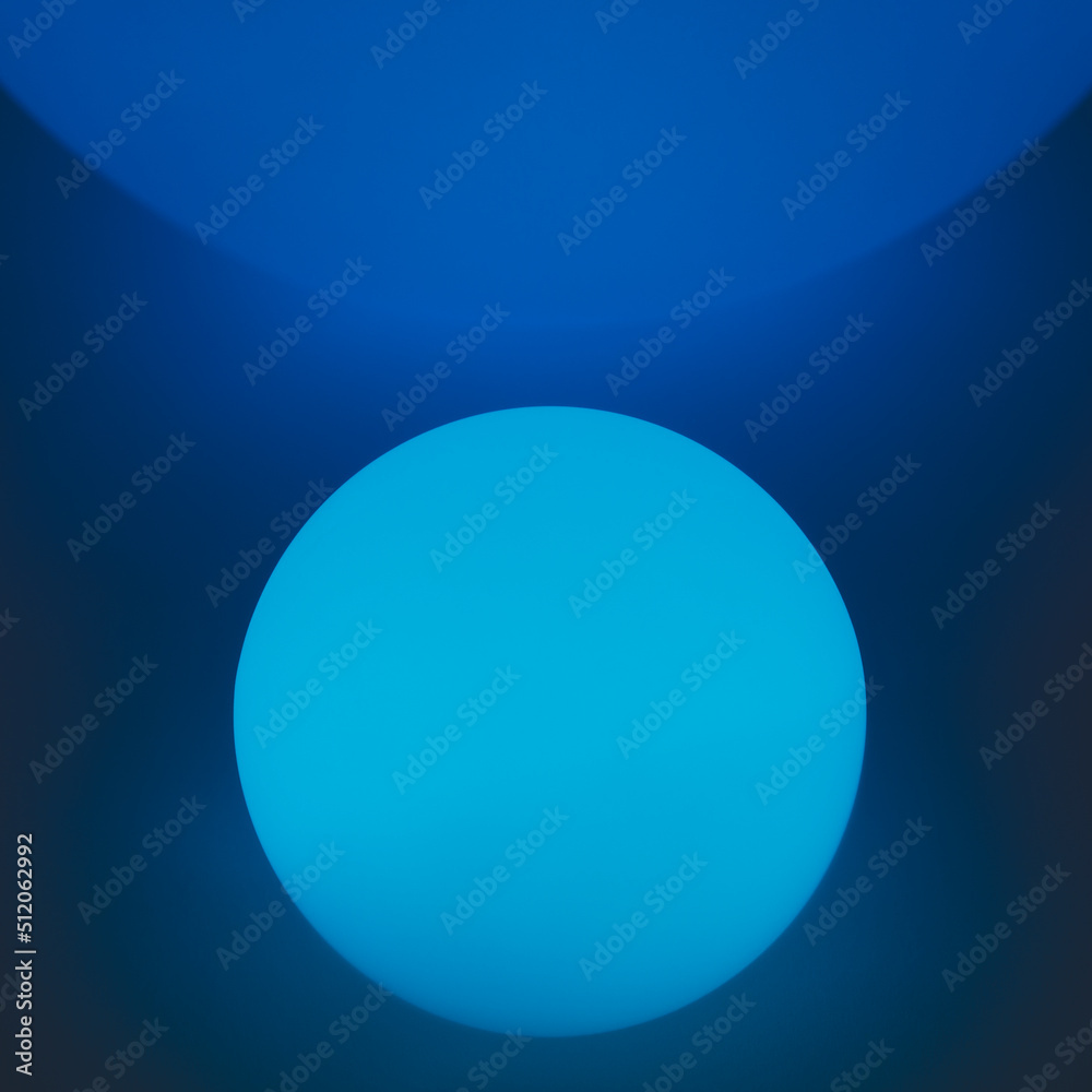 Glowing and illuminated spherical coloured orbs on a black background ...