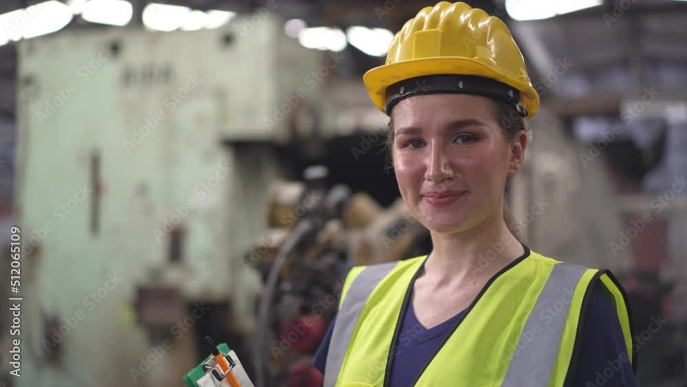Portrait of Caucasian female engineer or factory worker holding ...
