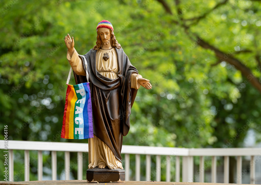 Jesus statue with the rainbow knit cap and LGBT pride flag with a peace ...