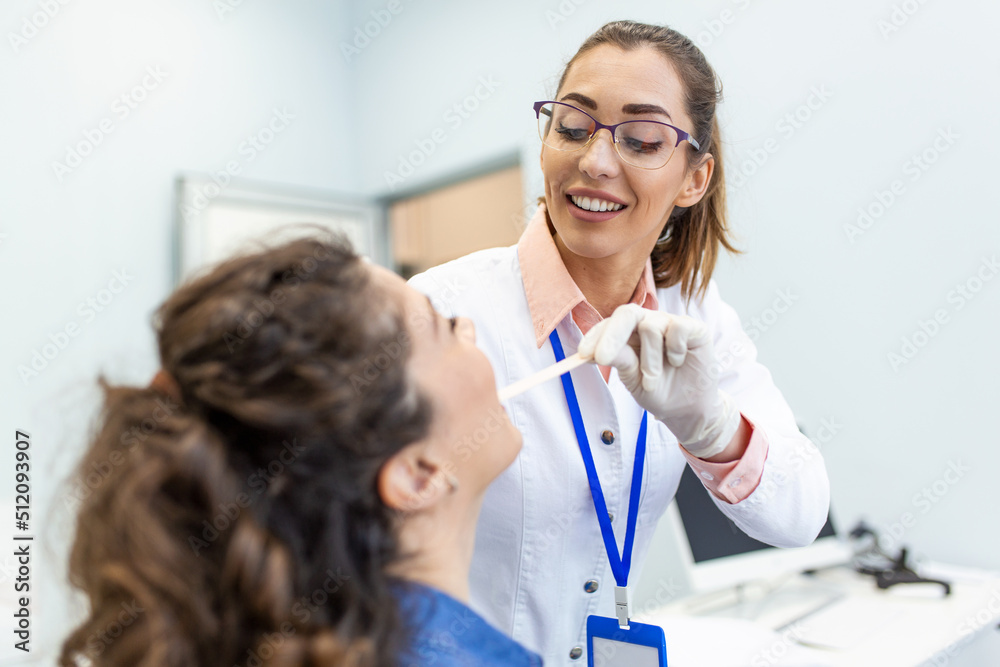 Doctor using inspection spatula to examine patient throat. ENT doctor ...