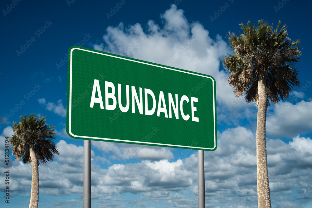 Highway sign with the word Abundance on a beautiful blue sky background ...