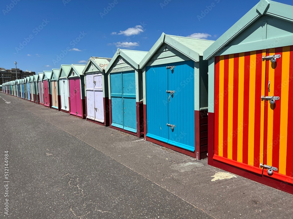 Colorful changing huts are on the beach in Hove, England near Brighton ...