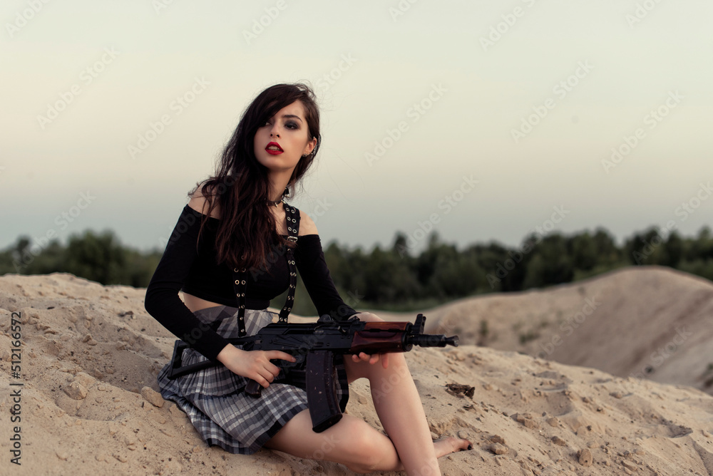 Girl with a gun in her hands Stock Photo | Adobe Stock