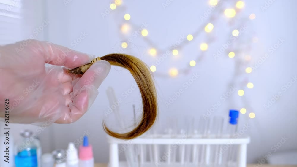 close-up of female hands, laboratory assistant in hair growth clinic ...