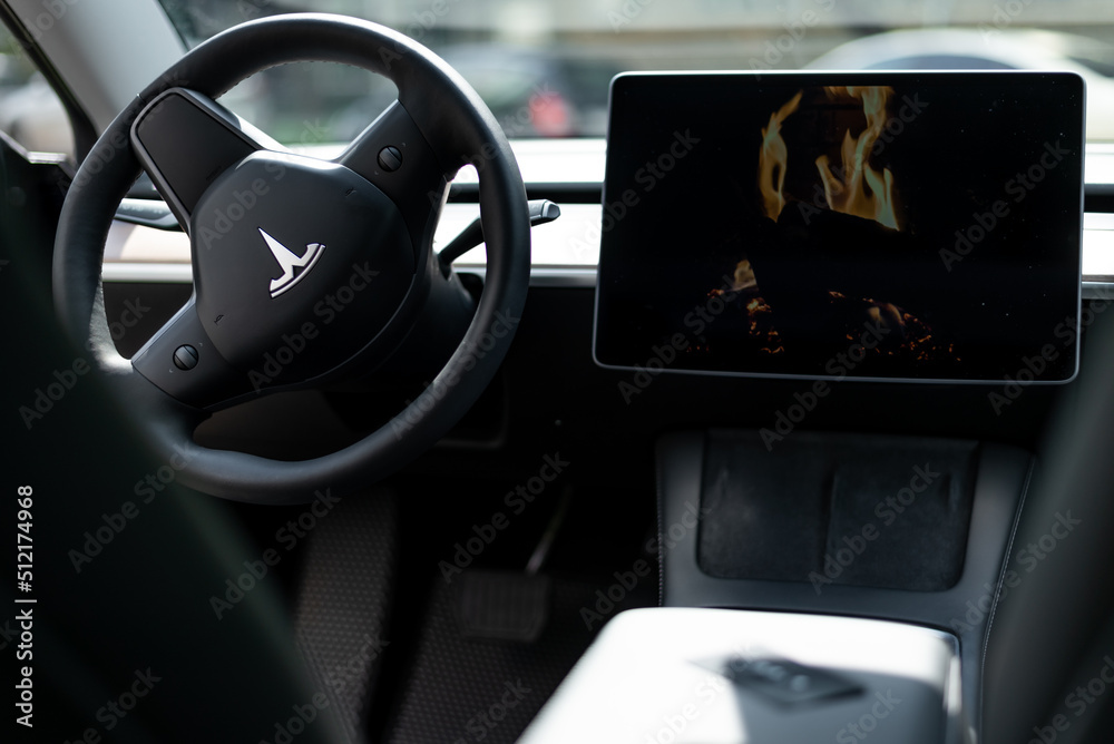 steering wheel and screen in the interior of the tesla electric car ...
