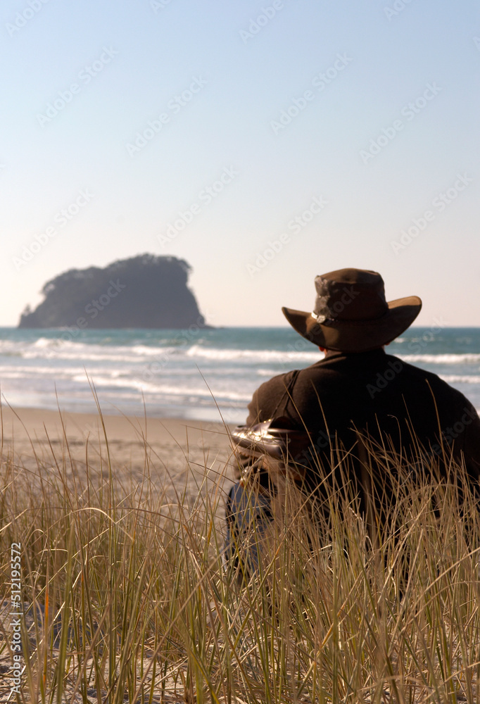 Back view of a man wearing an akubra hat and shoes slung over his ...