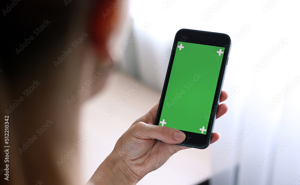 Chroma key mockup on smartphone in hand. Woman holds mobile phone ...