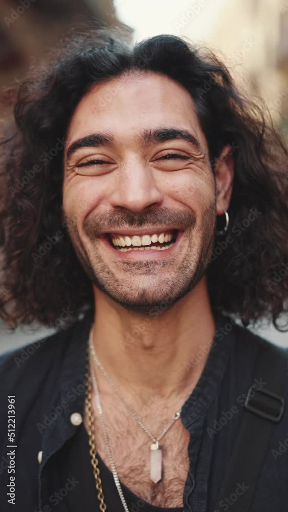 VERTICAL VIDEO: Young attractive italian guy with long curly hair and ...