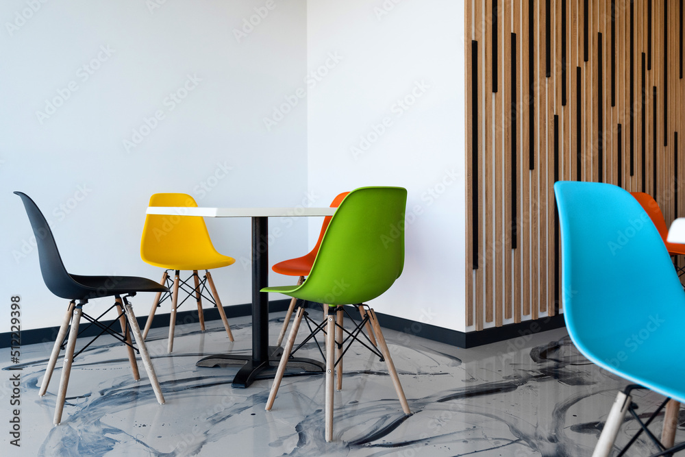a modern cafe with colorful chairs and white tables. Lounge bar Stock ...