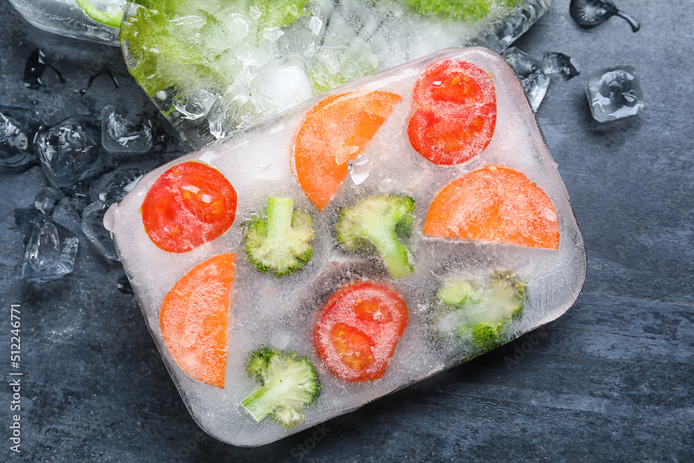 Fresh cut vegetables frozen in ice on dark background Stock Photo ...