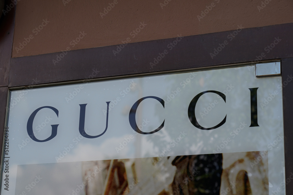 gucci store sign text and brand logo on windows facade luxury leather ...