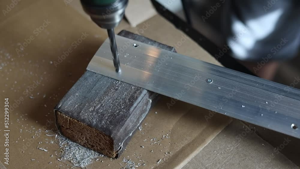 Drill close-up. The master drills holes in the metal panel. Repair work ...