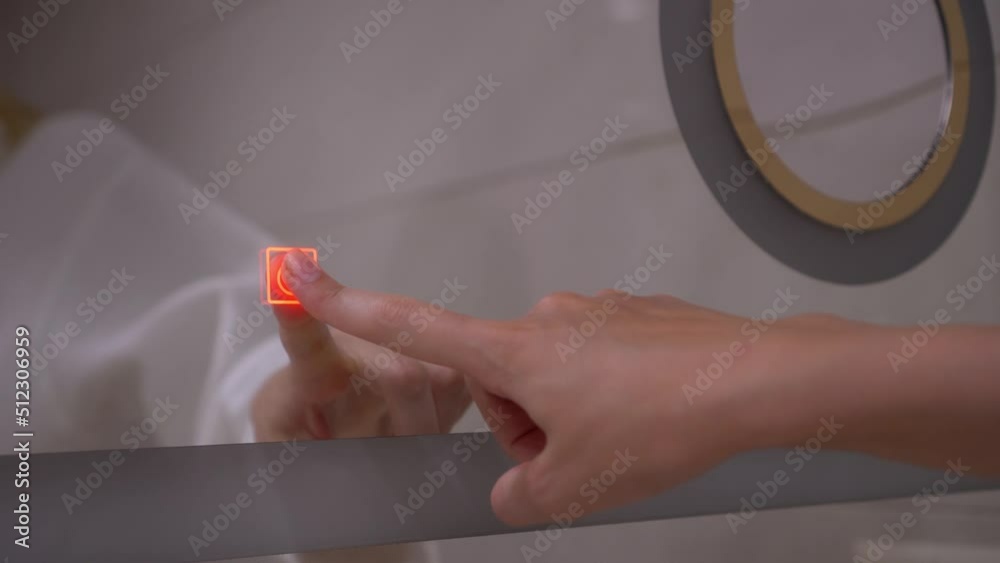 Touching glow button on mirror display with your finger. technology in ...