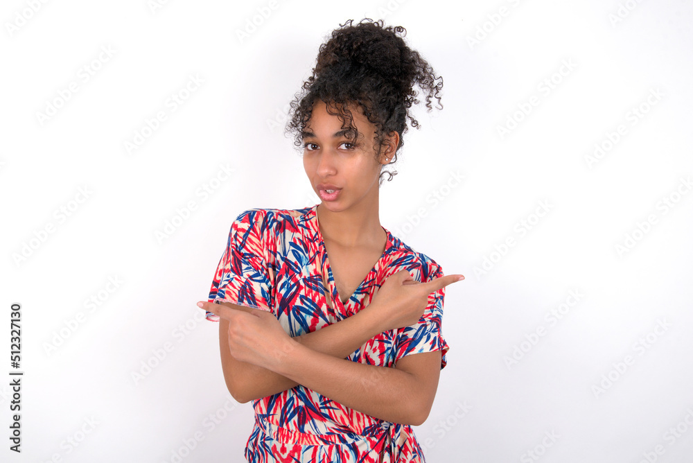 Confused Young African American woman wearing colourful dress over ...
