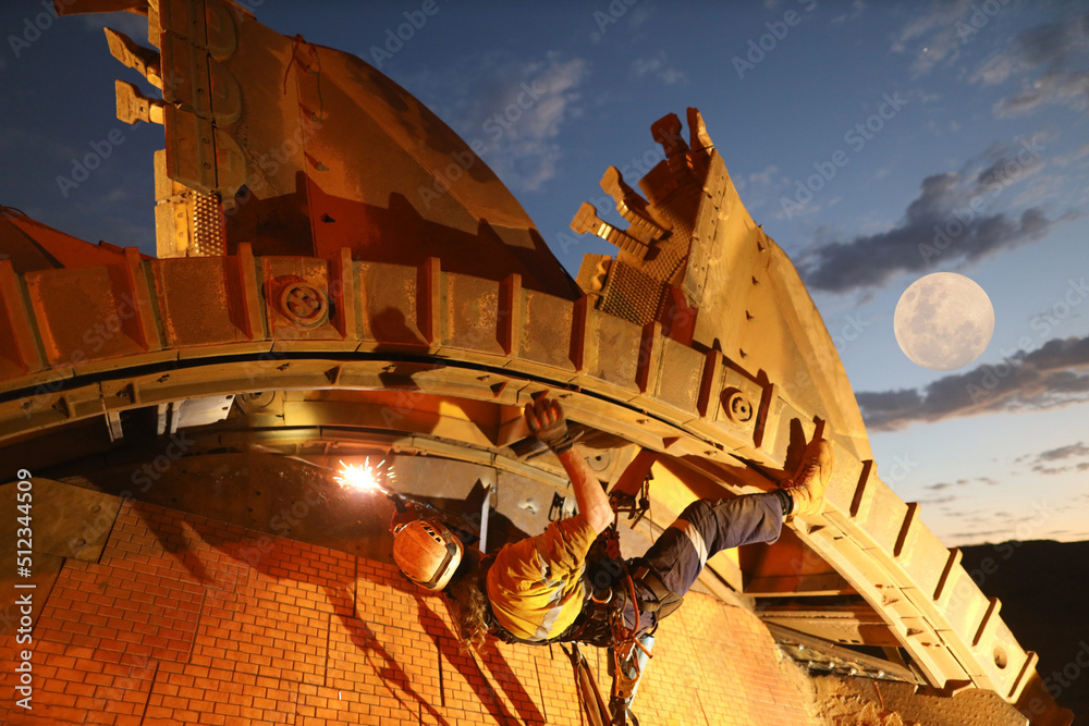 Rope access maintenance welder abseiler wearing fall safety body safety ...