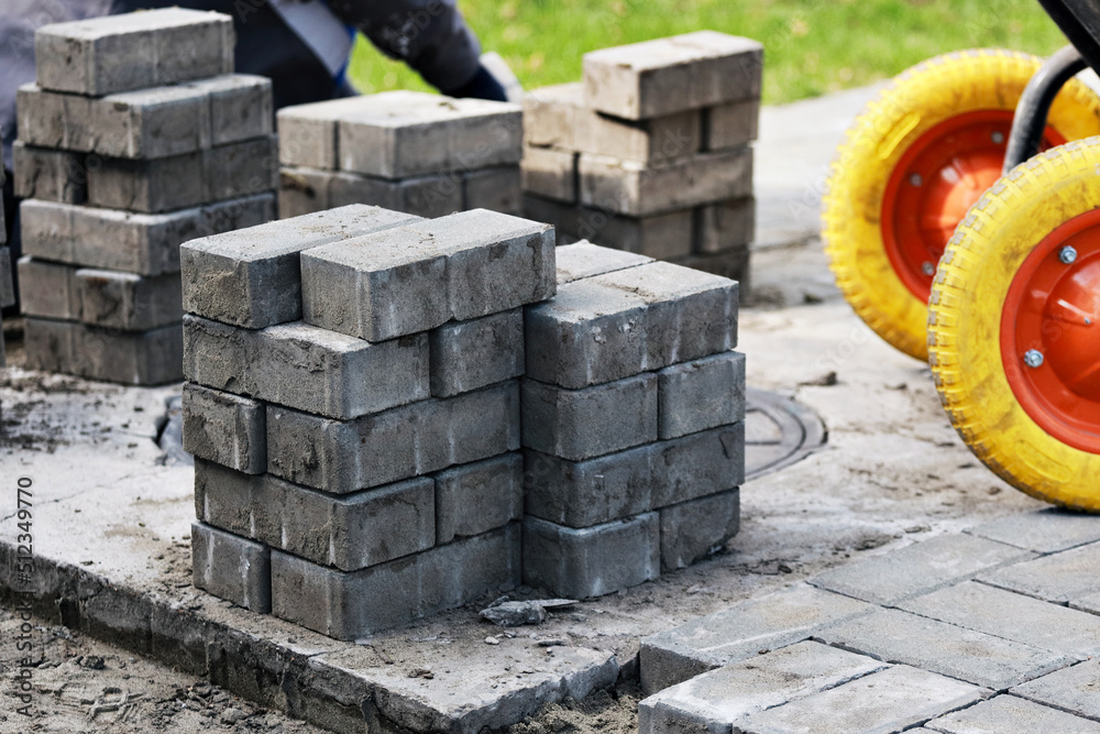View of new paving slabs and concrete blocks on summer day at ...