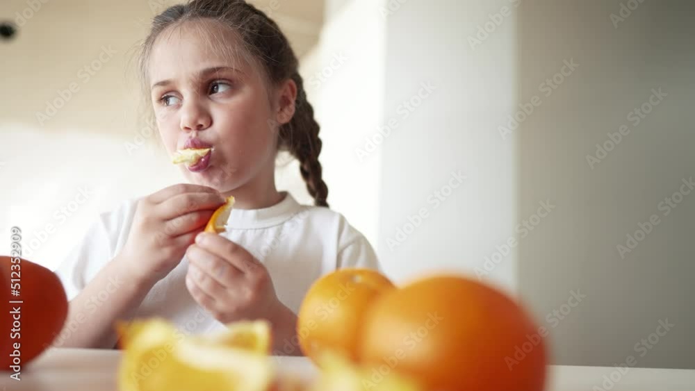 girl child eating oranges. happy family fruit dream healthy food kid concept. little girl ...