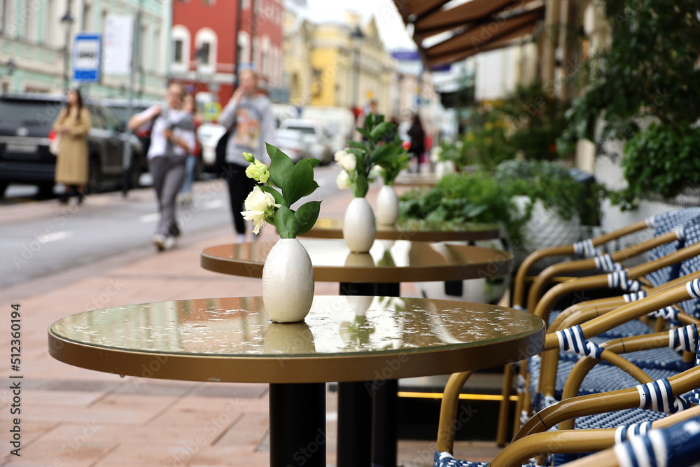 Street cafe in summer city with empty wet tables outdoor on walking ...