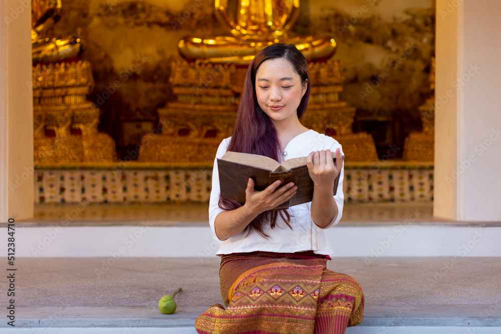 Asian buddhist woman is reading Sanskrit ancient Tripitaka book of Lord ...