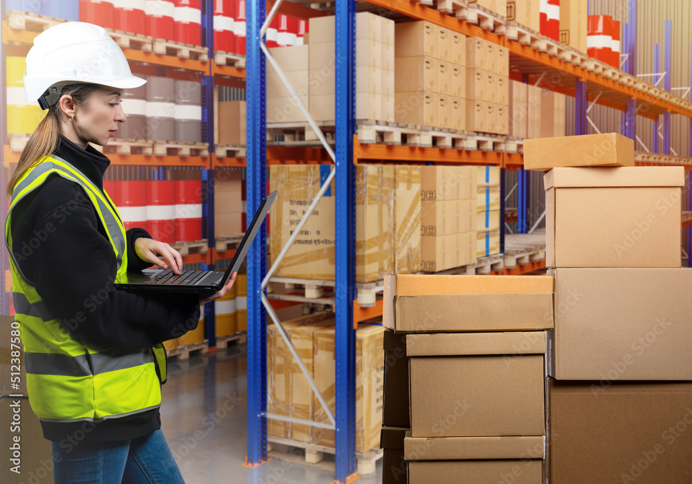 Warehouse manager woman. Girl in protective helmet in front parcels ...