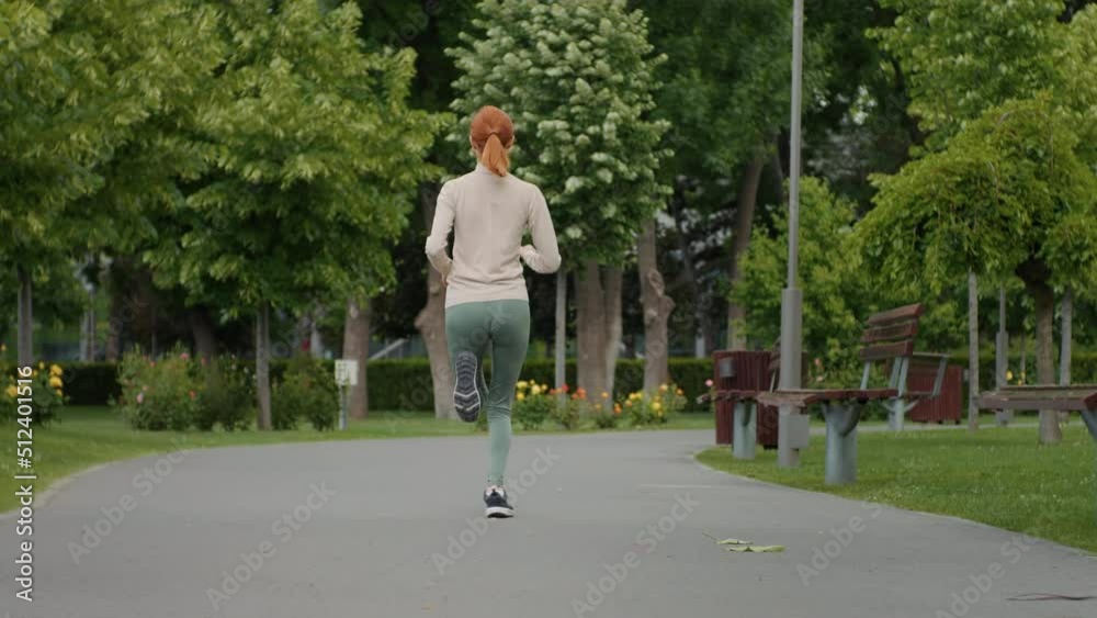 Back view of anorexic woman who started doing jogging in the morning ...