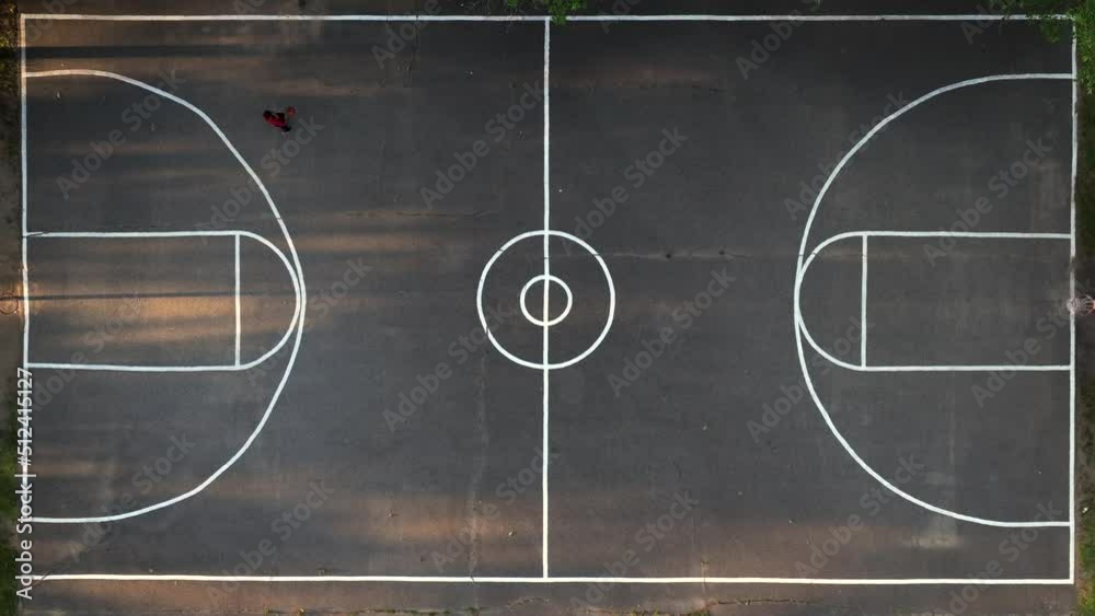 A top down view directly above a basketball court in a park on Long ...