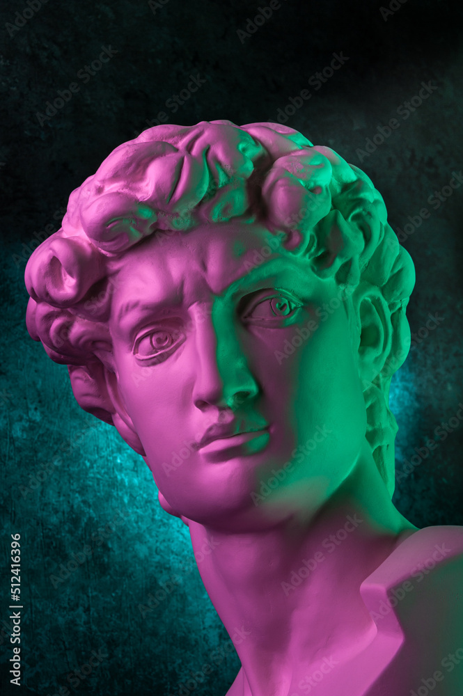Gypsum copy of head statue David in bright neon colors for artists on a ...