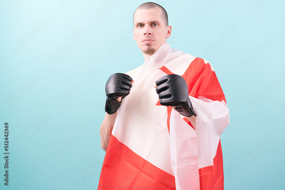 A confident MMA fighter in black gloves and a Canadian flag ready to ...