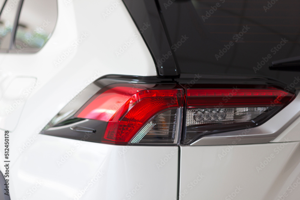 The back of a white expensive crossover car: Close up detail on one of ...