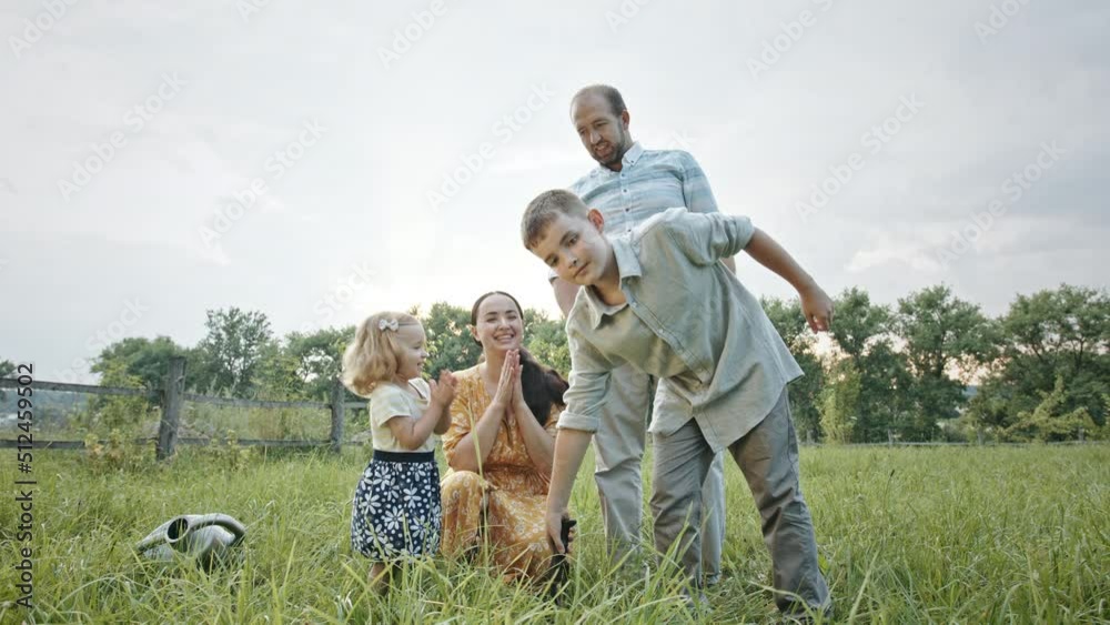 Family spending time near planted tree sapling. Ground level of ...