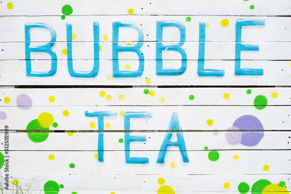 Text in English Bubble tea on white wooden plank background. Food and ...