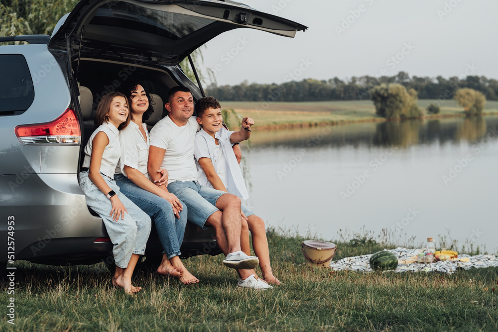 Happy Four Caucasian Members Family Sitting in Trunk of Minivan Car ...