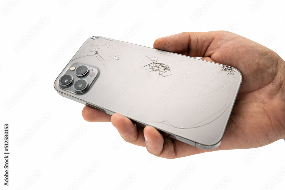 Man hand holding modern smartphone with broken back glass on white ...