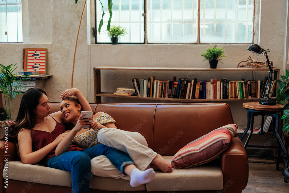 Lesbian couple cuddling on couch Stock Photo | Adobe Stock Lesbian couple cuddling on couch Stock Photo | Adobe Stock