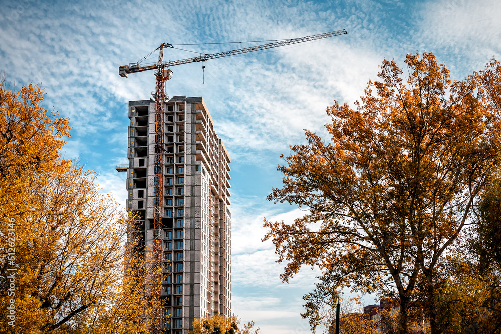 Crane builds a residential apartment building Stock Photo | Adobe Stock
