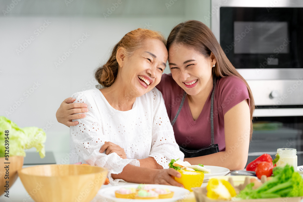 mother and daughter cooking in the kitchen, mother and daughter hugging ...