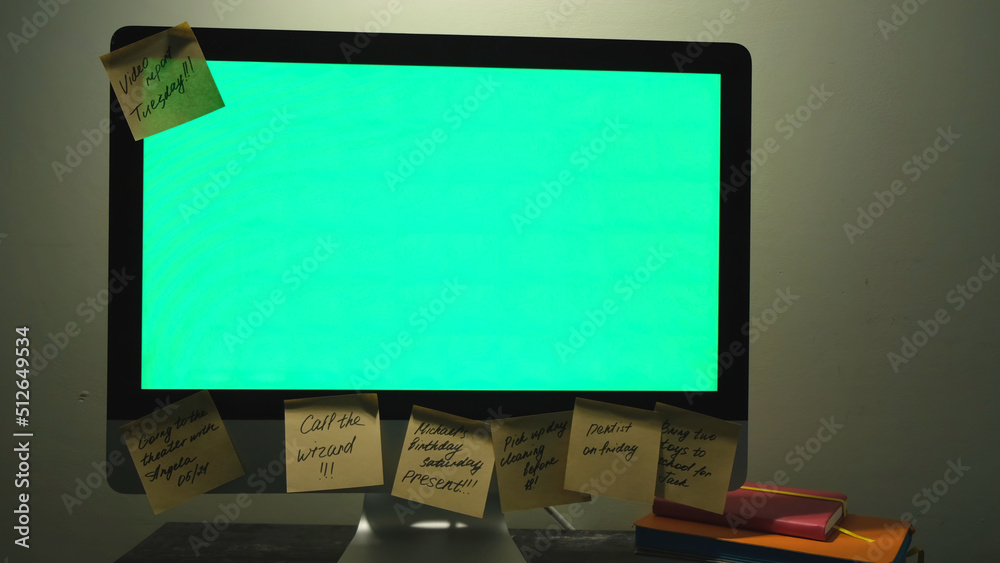 Stylish and creative desk with computer green screen and many sticky ...