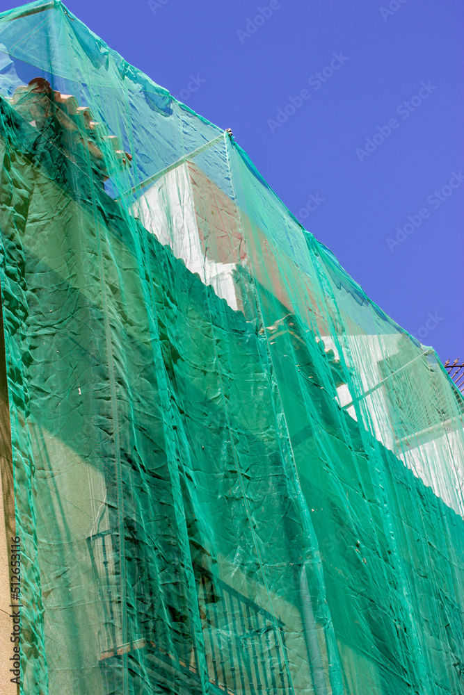 Protective net. Reconstruction of facade of historic classical ...