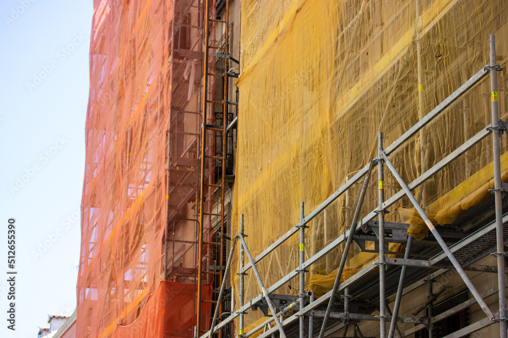 Reconstruction of historic apartment building facade on city street in ...