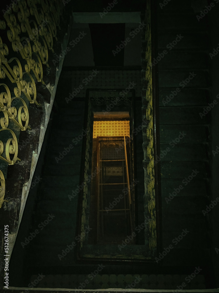 Old Square Spiral staircase perspective, view from above. Green ...
