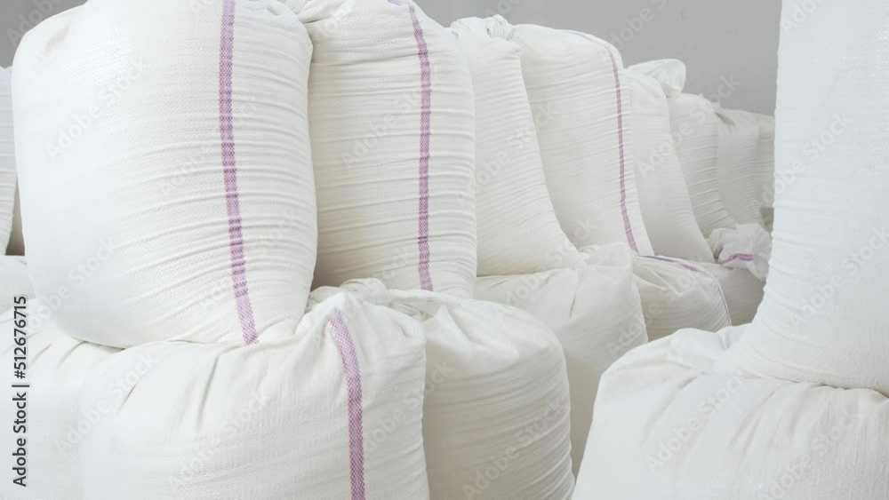 White sacks with flour, sugar, groats or pasta in a production ...