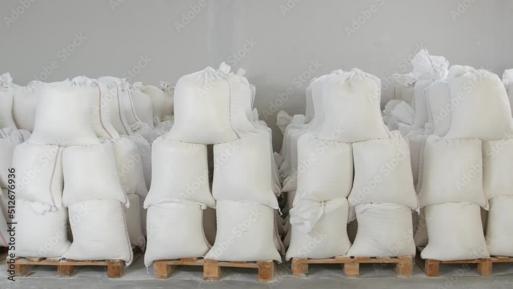 White sacks with flour, sugar, groats or pasta in a production ...