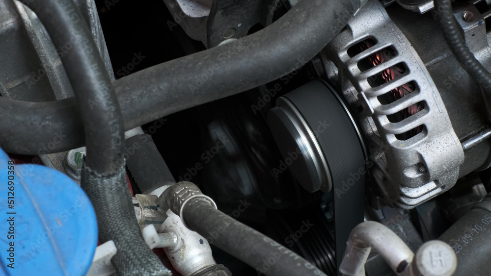 close view of car's generator which is spinning and giving voltage to ...