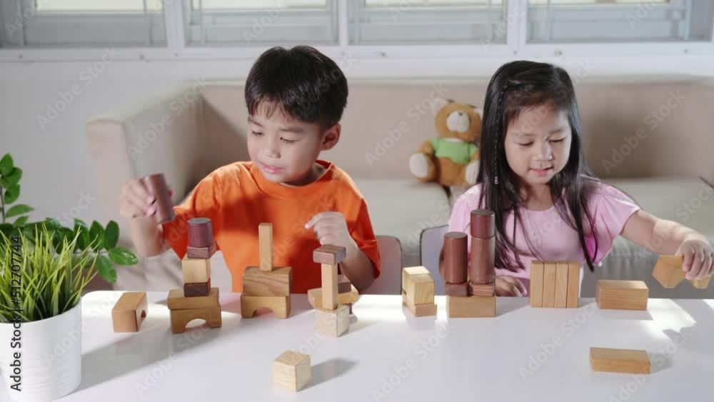 Happy little kids play wood block stacking board game at home, Children ...
