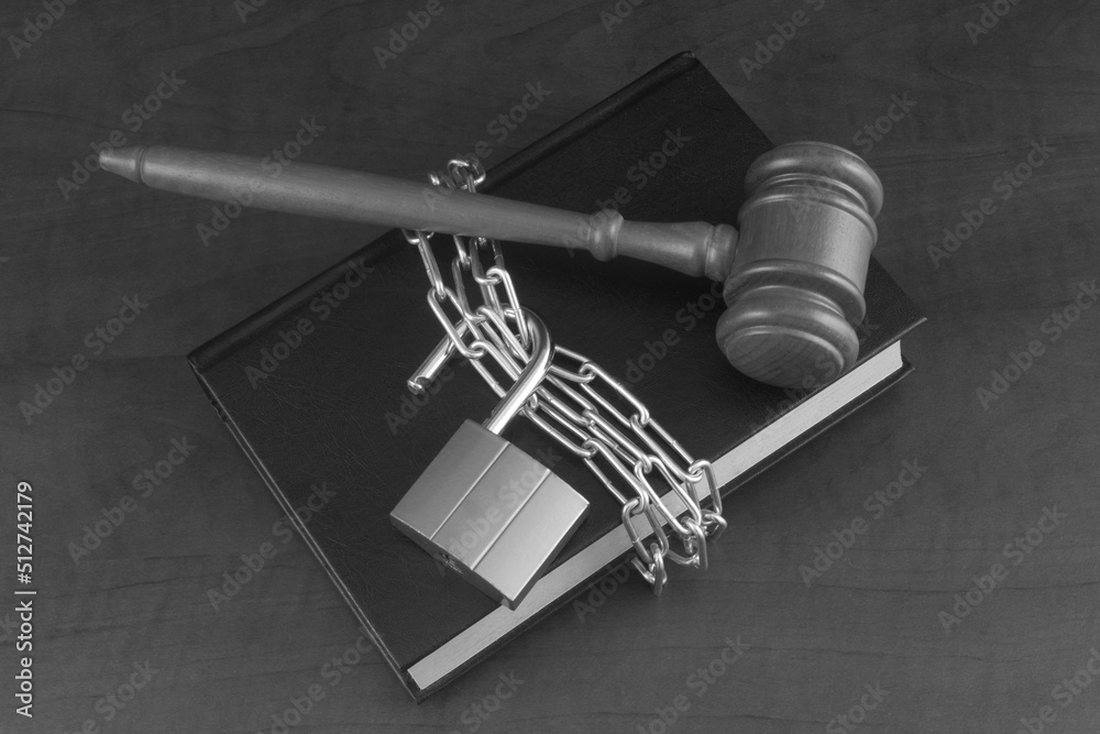 Open access to information concept. Judge gavel on chained book with ...