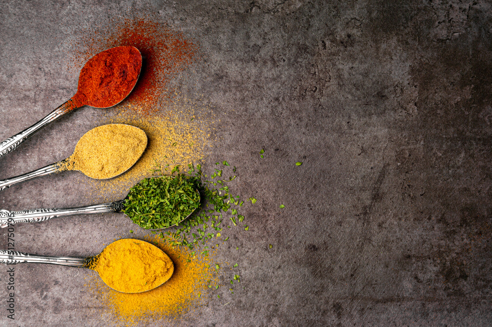 Assorted of colorful spices (red pepper powder, turmeric powder, black ...
